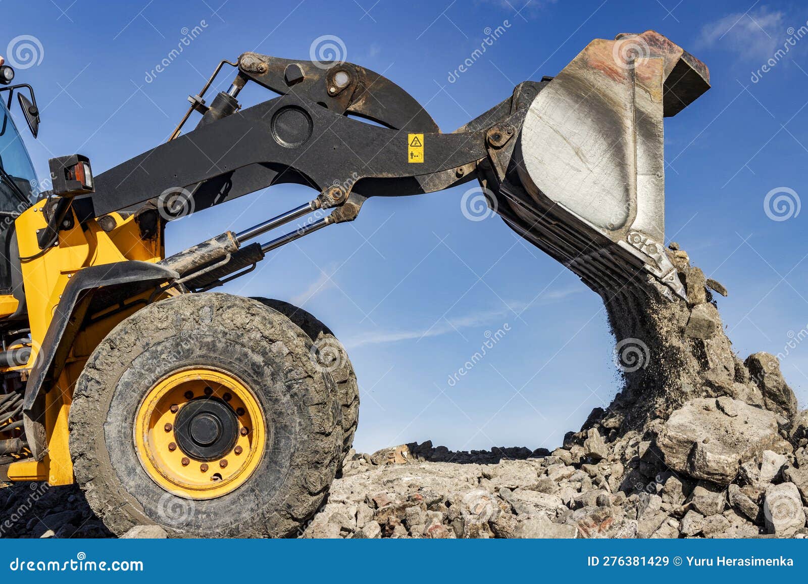 Powerful Front Wheel Loader or Bulldozer Working on a Quarry or ...