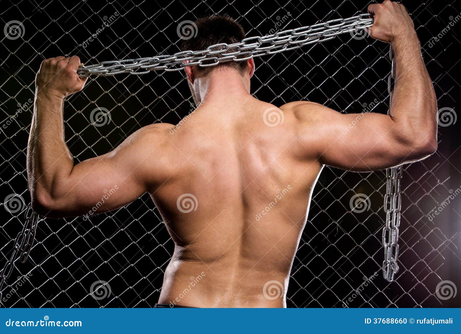 Powerful Guy with a Chain Showing His Muscles Stock Photo - Image of ...