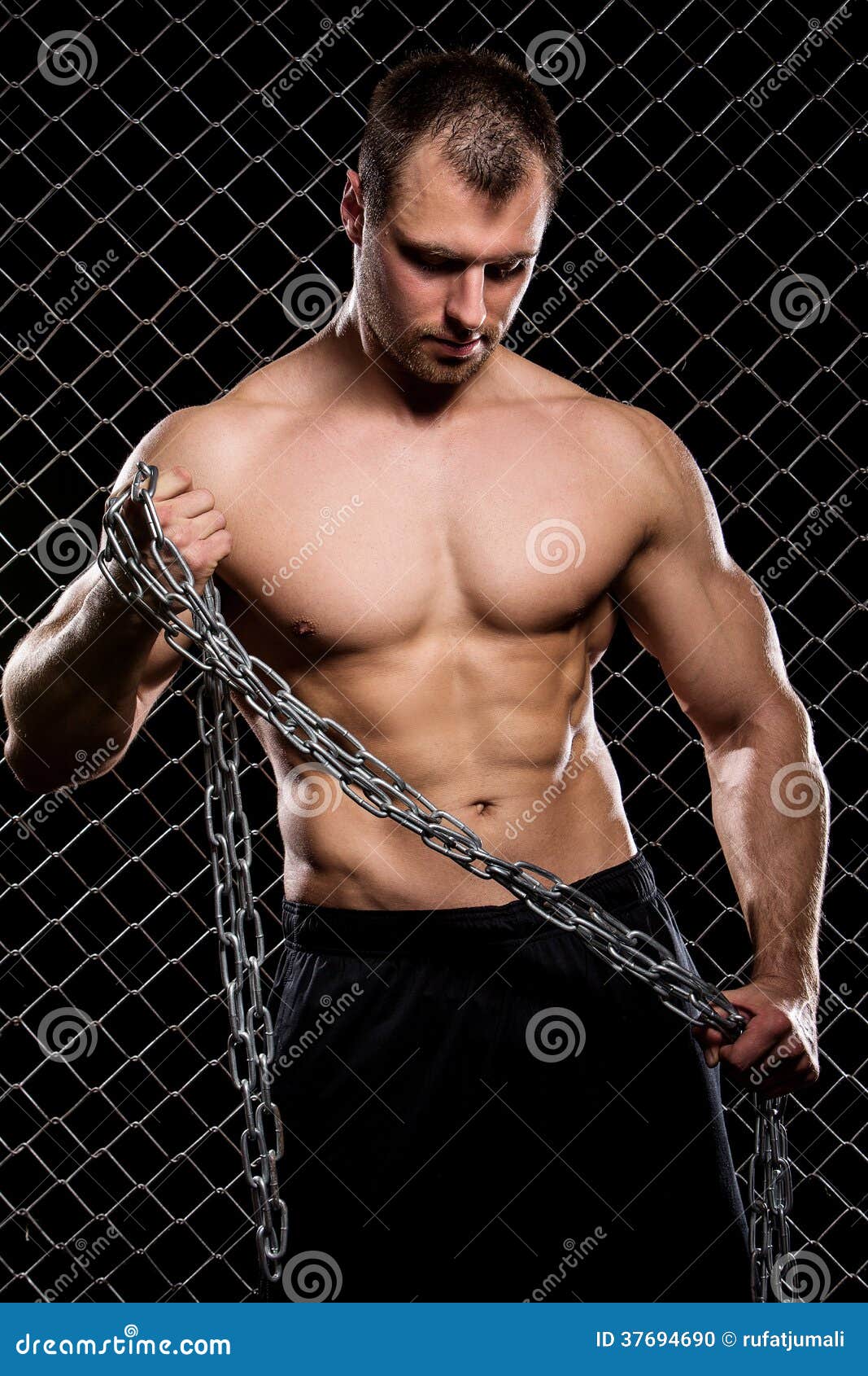 Powerful Guy with a Chain Showing His Muscles Stock Photo - Image of ...