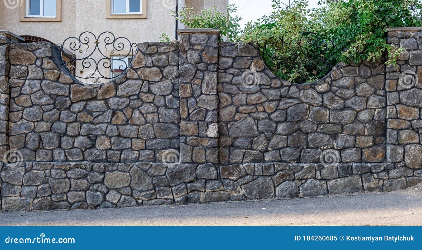 Powerful High Stone Fence with a Tree Behind Stock Image - Image of ...