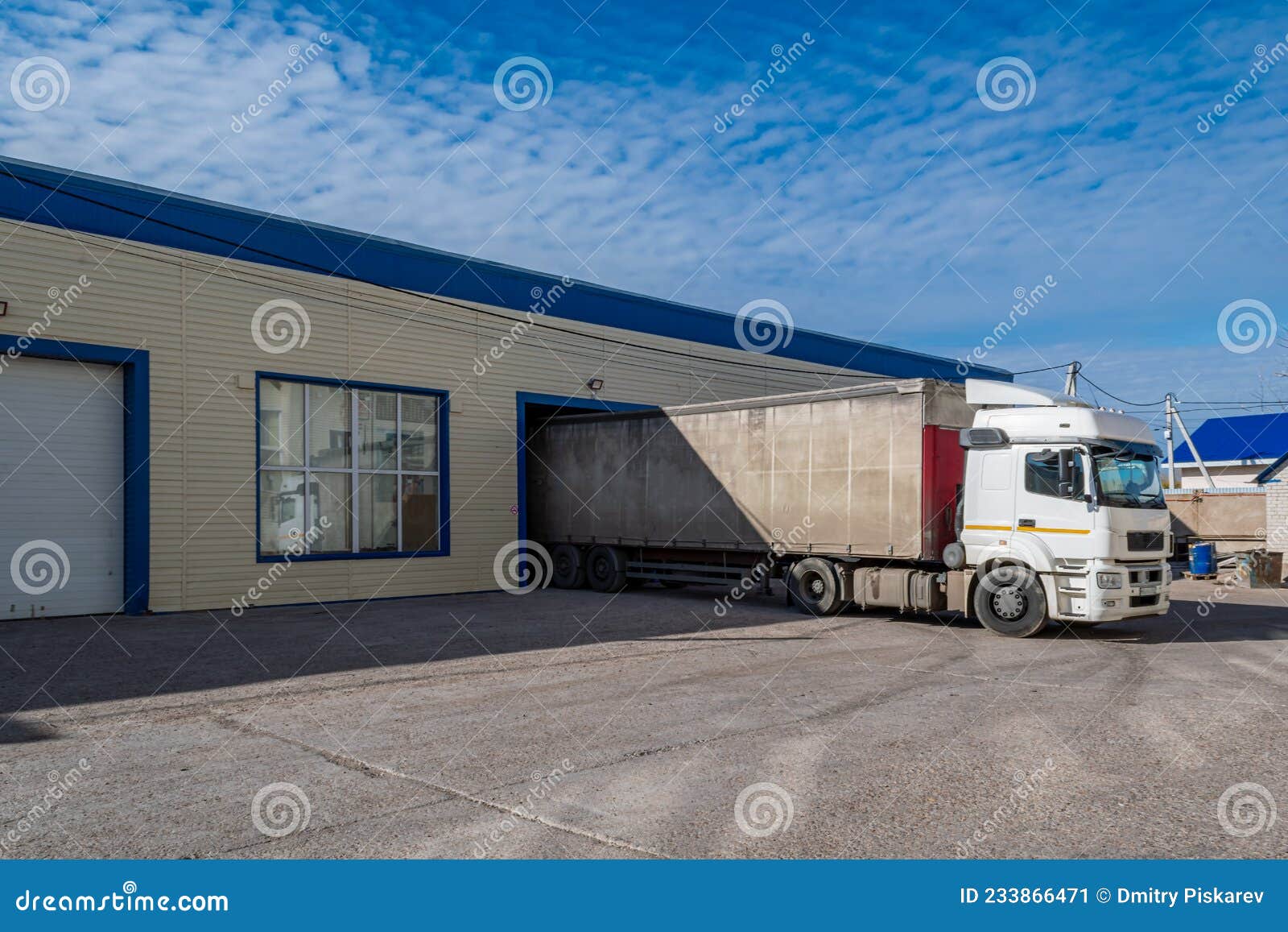 A Powerful and Large Truck with a Trailer Stands at the Loading and ...