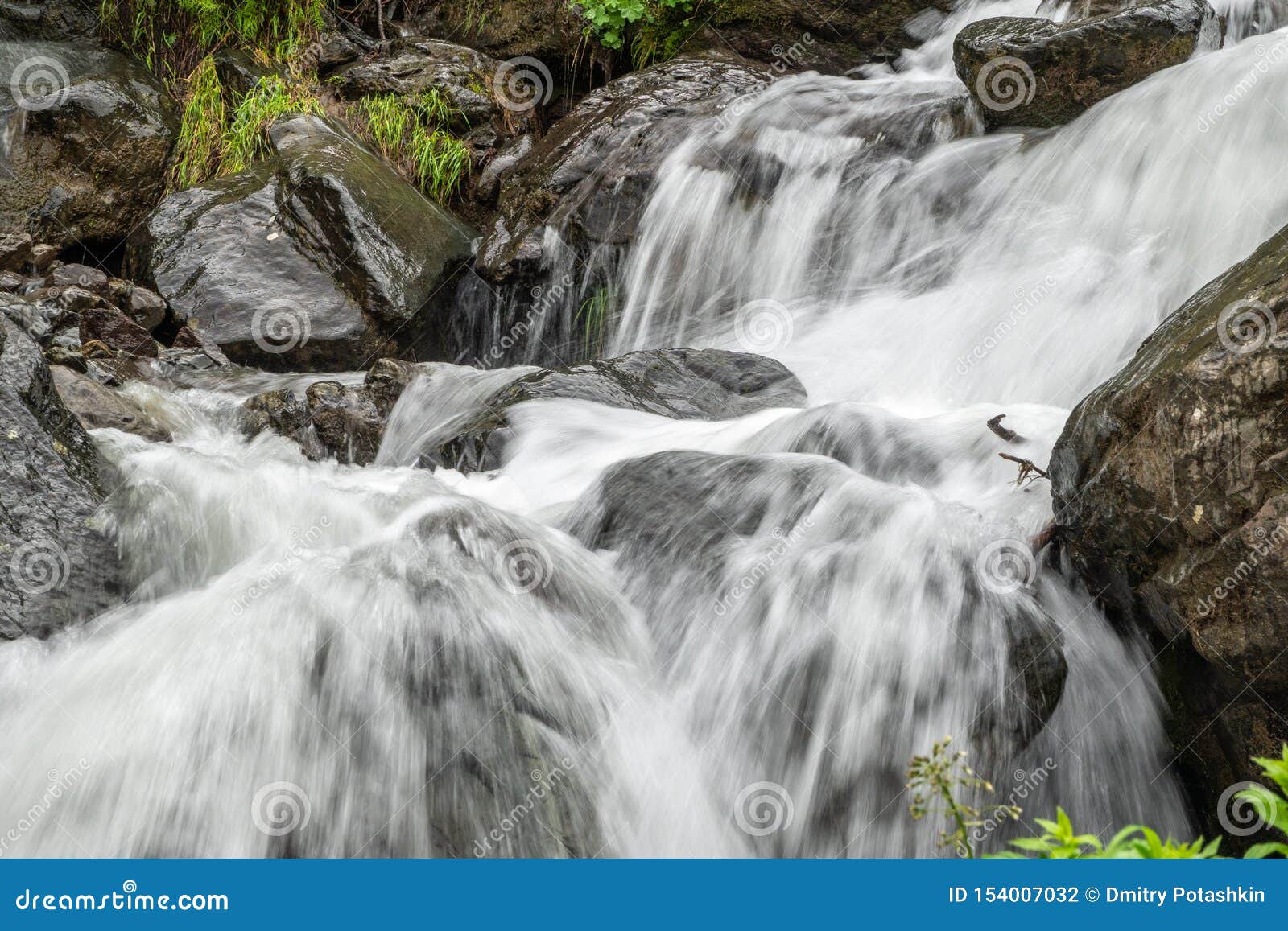 A Powerful Mountain Stream Flows Down from the Rocks and Stones Stock ...