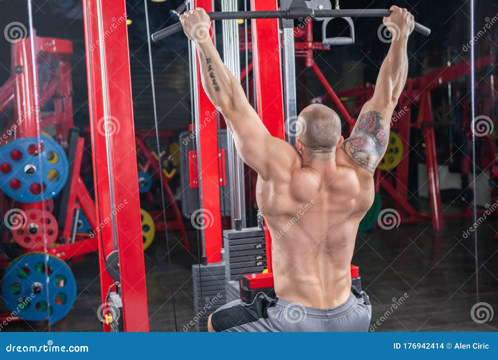 Powerful Muscular Man Doing Exercise for Back on the Lat Machine Stock ...