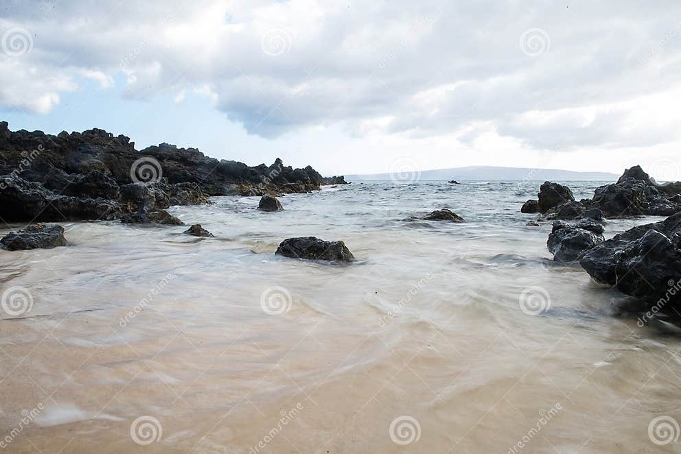 Powerful Ocean Current Rushing in To Beach Stock Image - Image of rocks ...