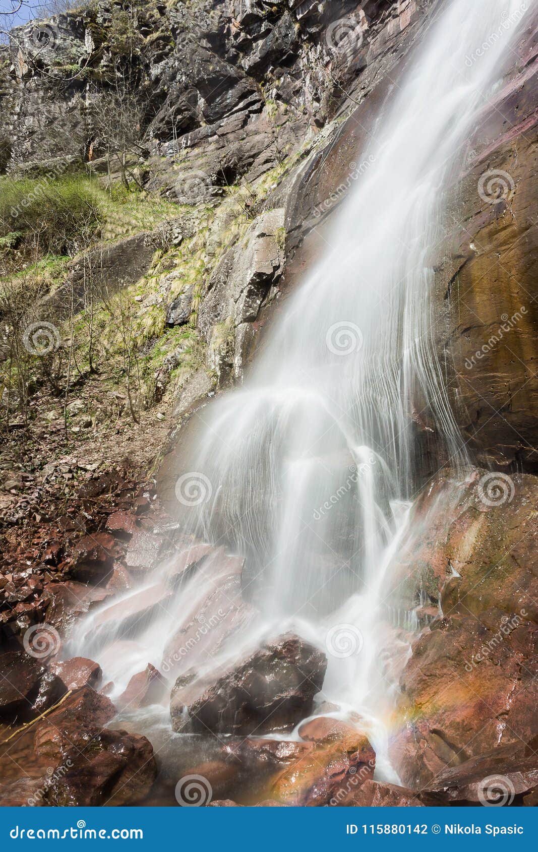 Powerful Sunlit Waterfall Splashing on the Rock Creating a Rainbow ...