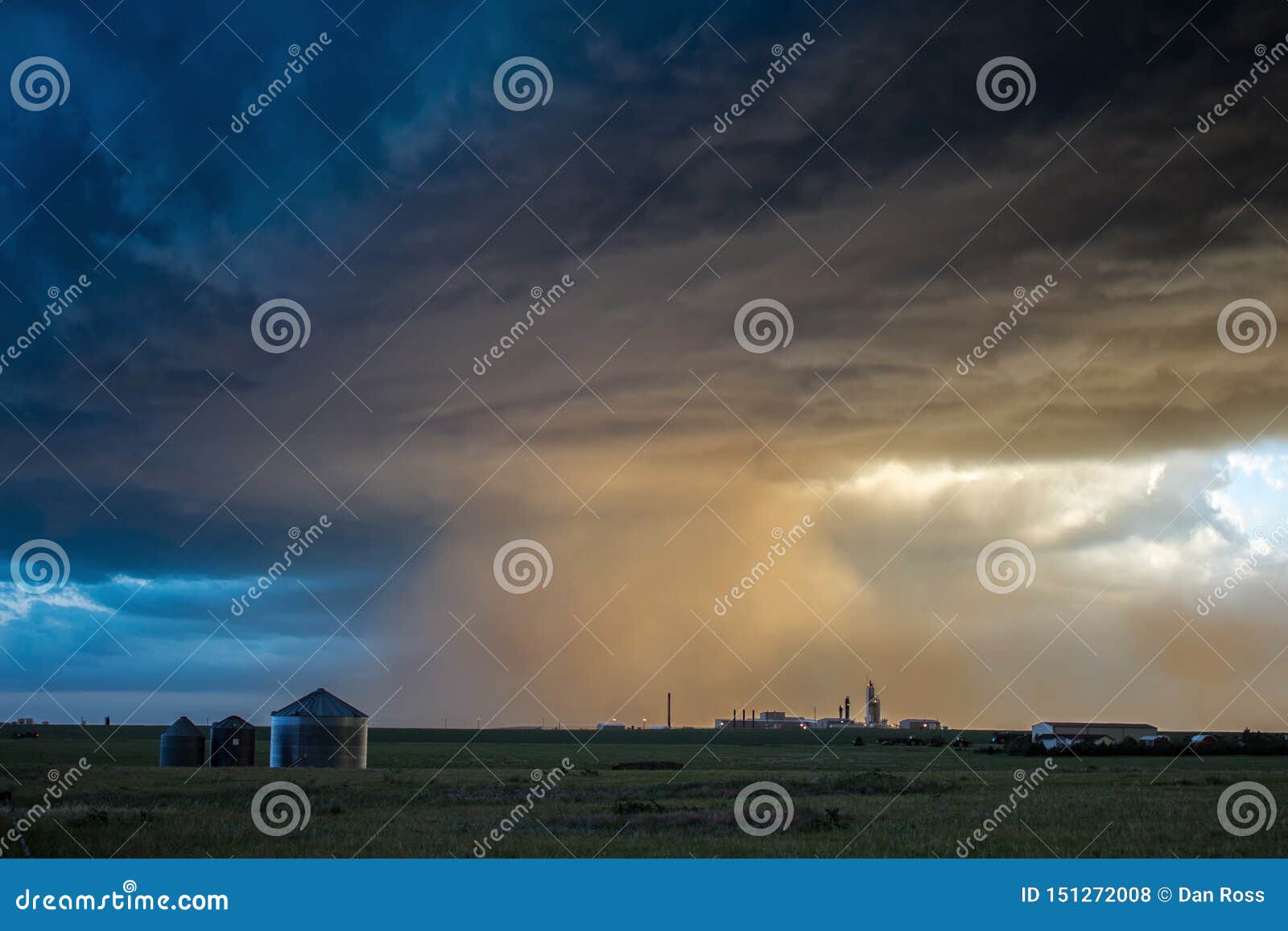 A Powerful Storm Blows Dust Clouds Over Farmland with the Setting Sun ...