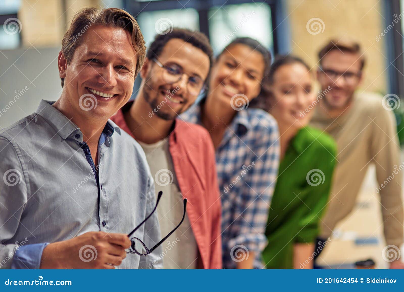 Powerful Team Group Of Young Happy Multiethnic Colleagues Smiling At