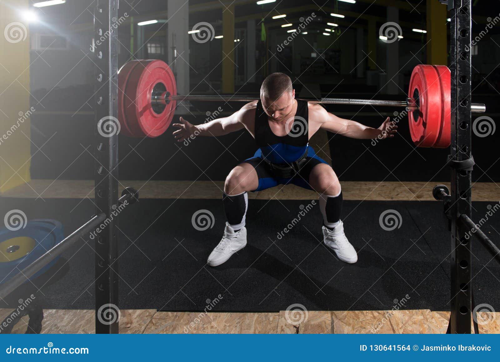 Powerlifter Using Barbell Exercising Legs Inside Gym Stock Photo ...