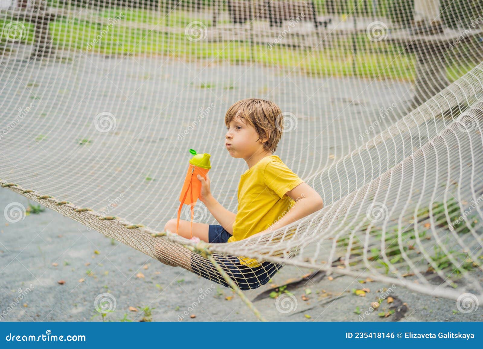 Practice Nets Playground. Boy Plays in the Playground Shielded with a ...