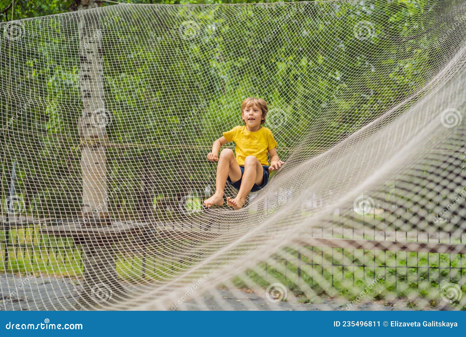 Practice Nets Playground. Boy Plays in the Playground Shielded with a ...