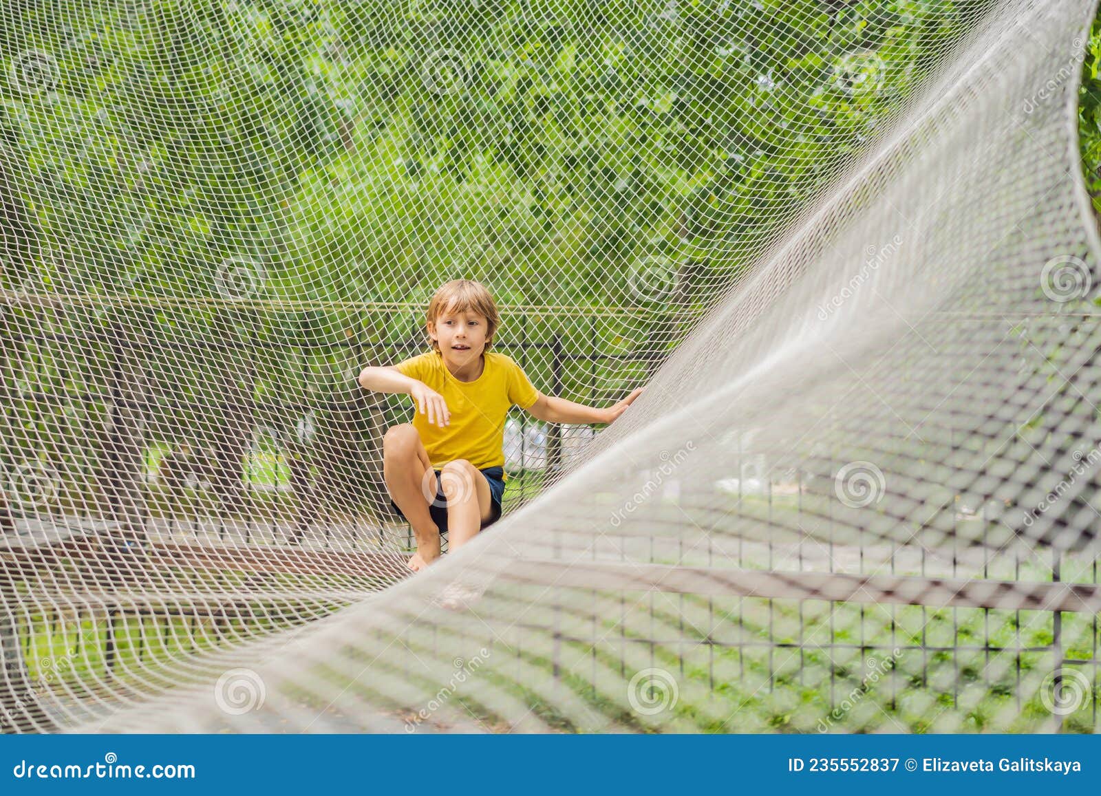 Practice Nets Playground. Boy Plays in the Playground Shielded with a ...