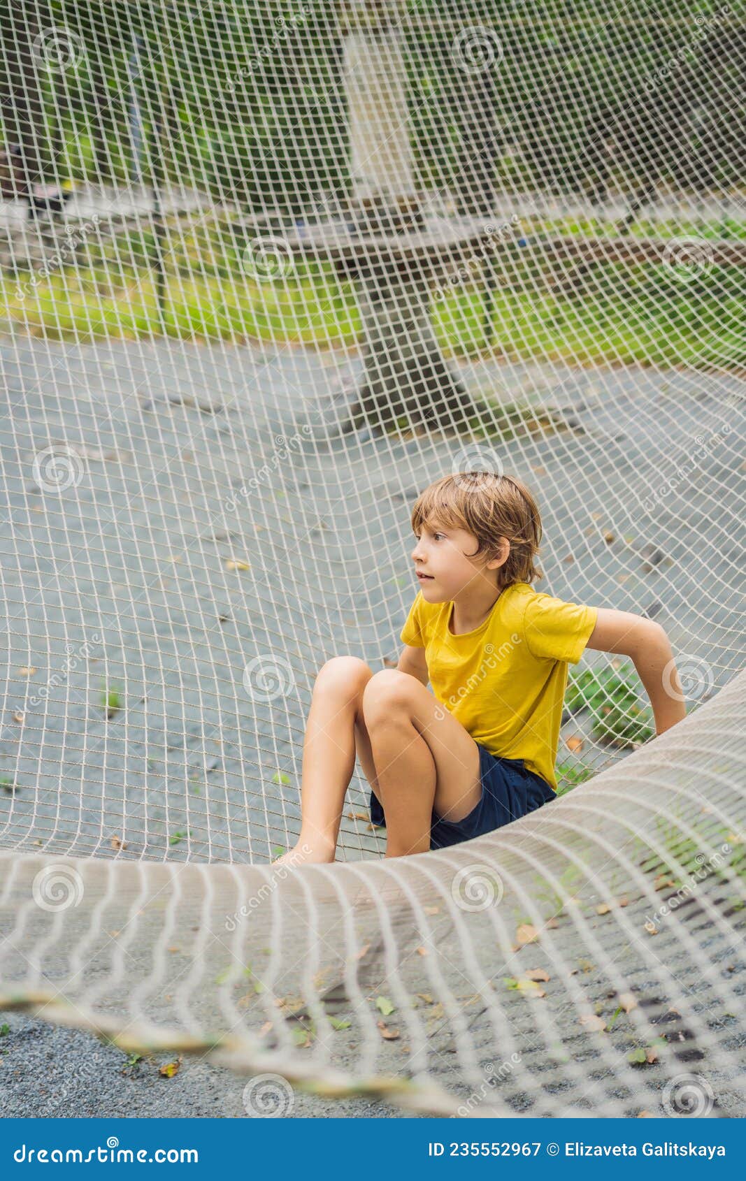 Practice Nets Playground. Boy Plays in the Playground Shielded with a ...