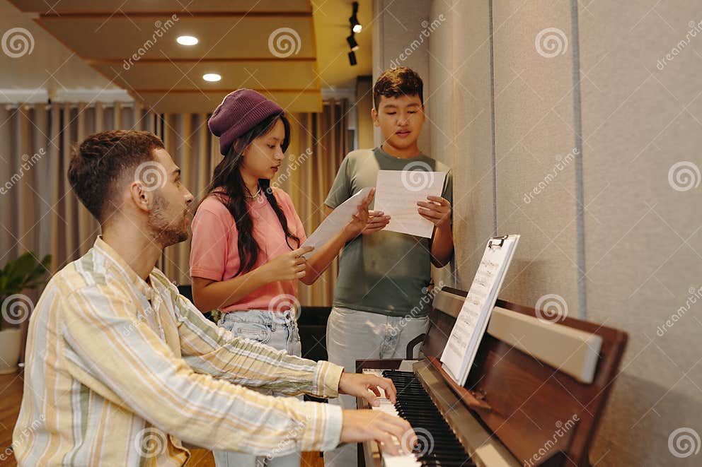 Practicing Music with Instructor at Piano Studio Stock Photo - Image of ...