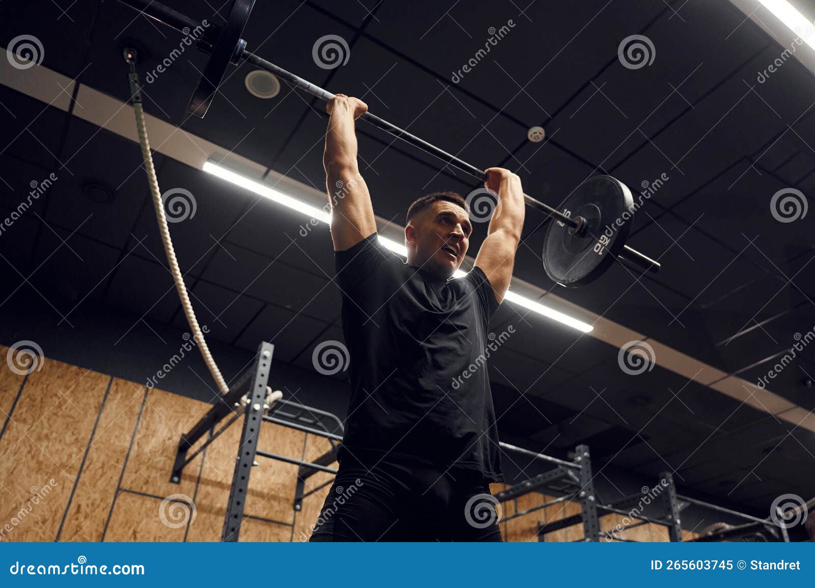 Practicing Process. Strong Man is Lifting Barbell in the Gym Stock ...