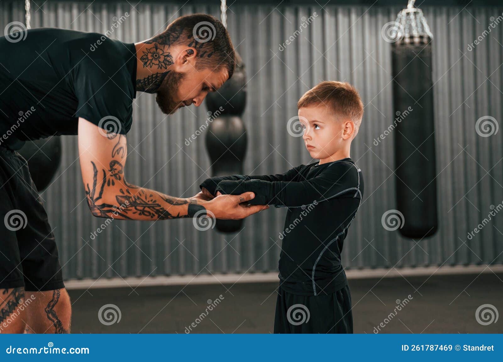 Practicing Together. Coach is Teaching the Boy Box Techniques Indoors ...