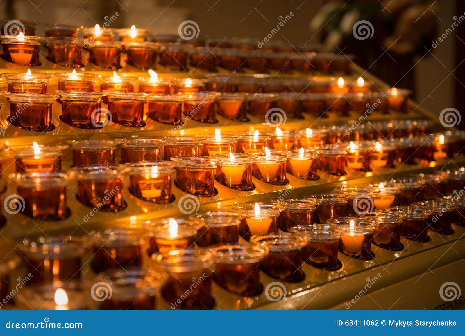 Prayer Candles Light Up the Darkness in a Church Stock Photo - Image of ...