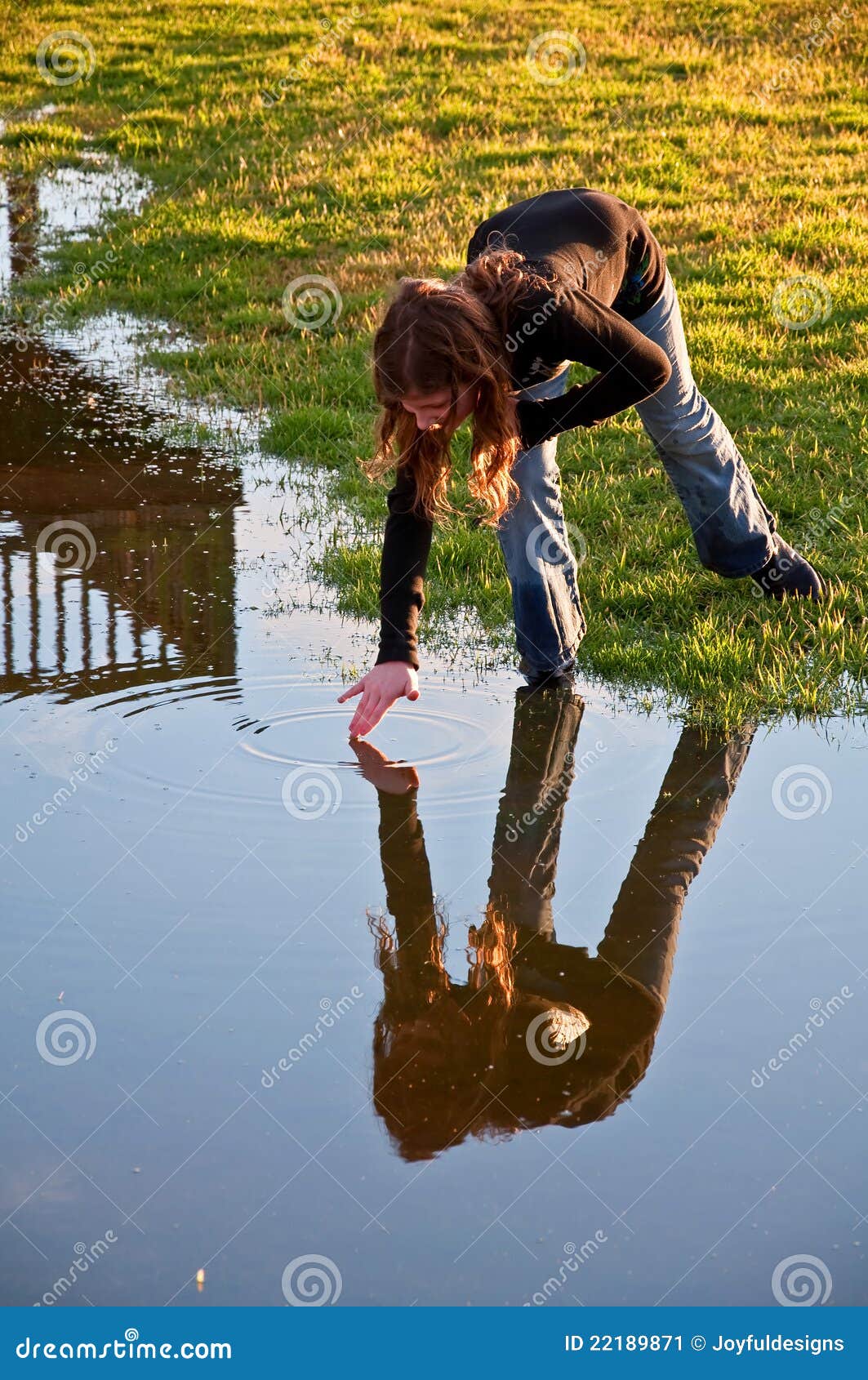 Pre-teem Girl Makes Ripple in Water with Hand Stock Image - Image of ...