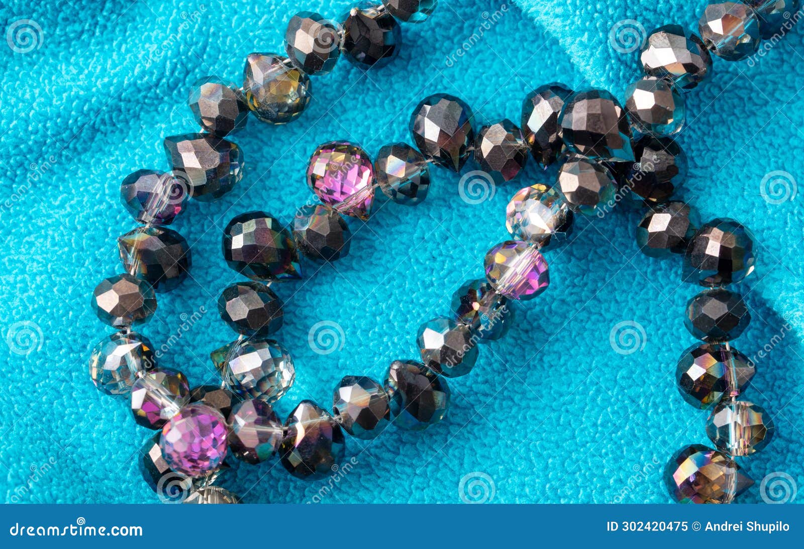 Precious Stones on Beads on Blue Fabric. Background Stock Image - Image ...