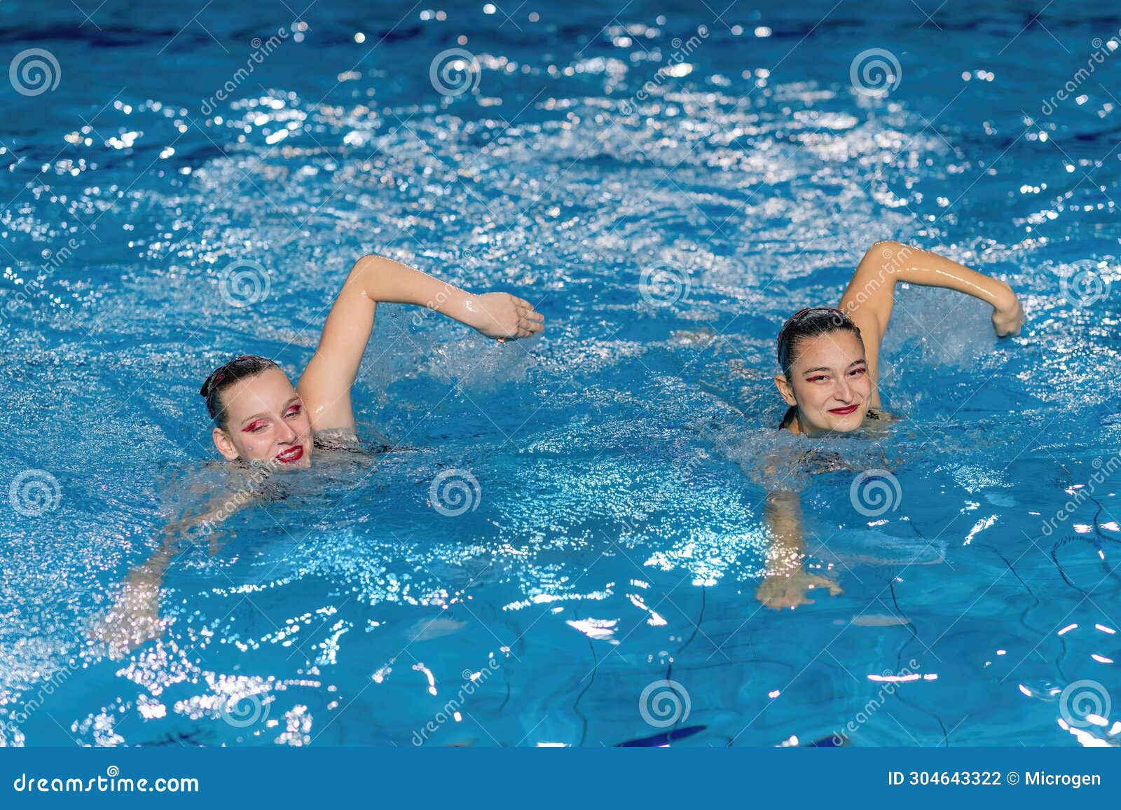 Precision and Elegance As the Synchronized Swimming Duo Performs Their ...
