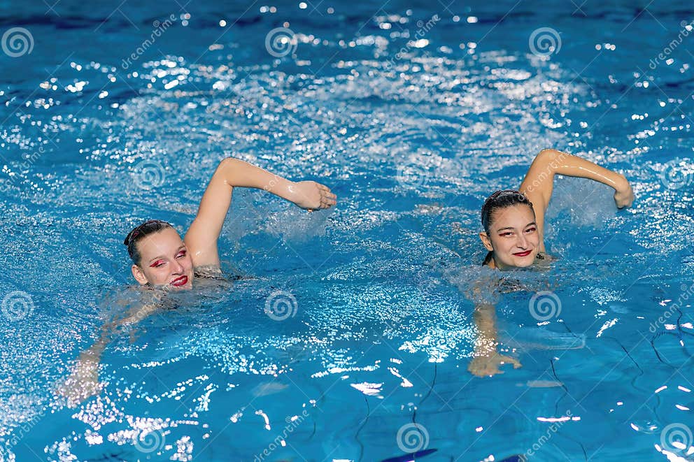 Precision and Elegance As the Synchronized Swimming Duo Performs Their ...
