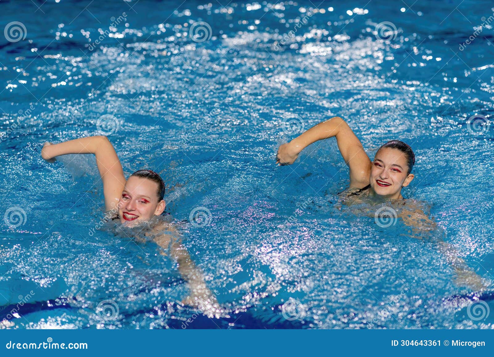 Precision and Elegance As the Synchronized Swimming Duo Performs Their ...
