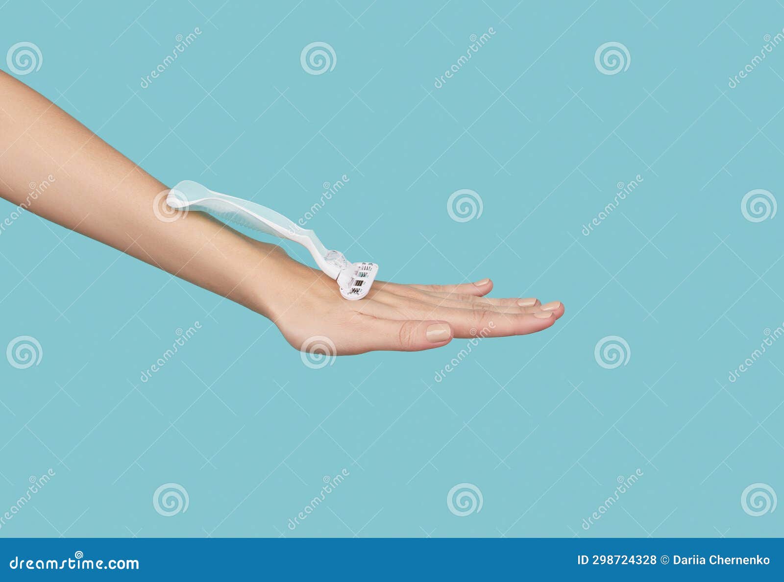 Precision in Hand: a Razor Held Against a Striking Blue Backdrop ...