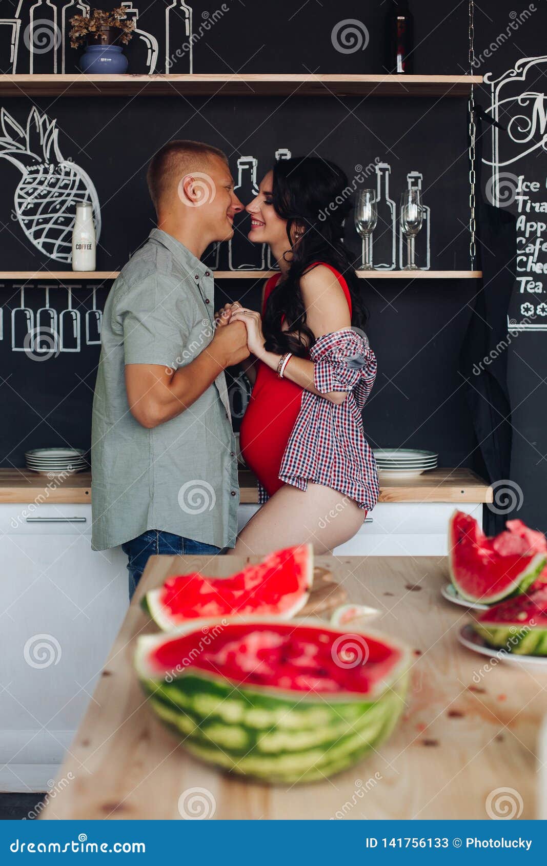 Pregnant Brunette Wife Looking At Blonde Handsome Husband Stock Image
