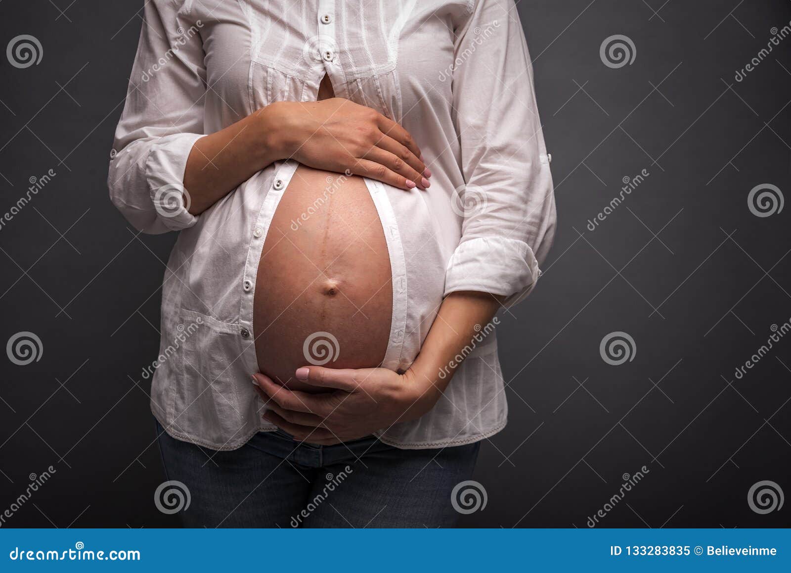 Pregnant Girl With A Bare Belly On Gray Background Stock Image Image
