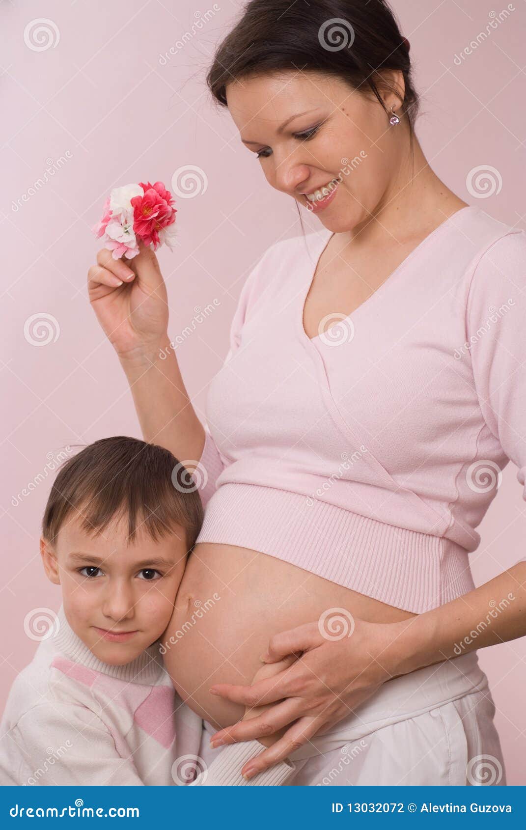 Pregnant Mother Hugging Her Son Stock Photo - Image of copy, flowers ...
