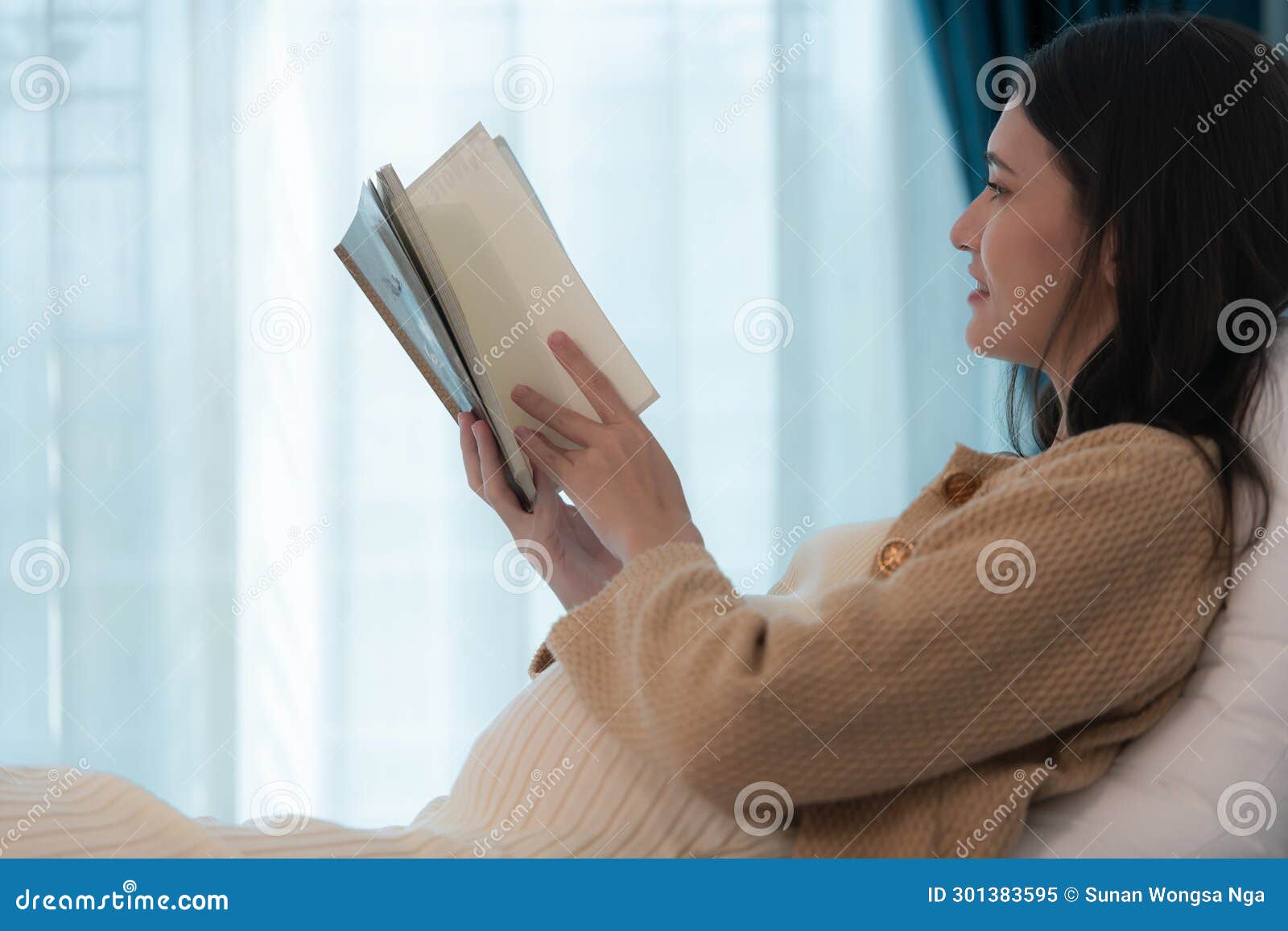 Pregnant Woman Reading a Stories To Her Unborn Child in the Living Room ... Pregnant Woman Reading a Stories To Her Unborn Child in the Living Room ...
