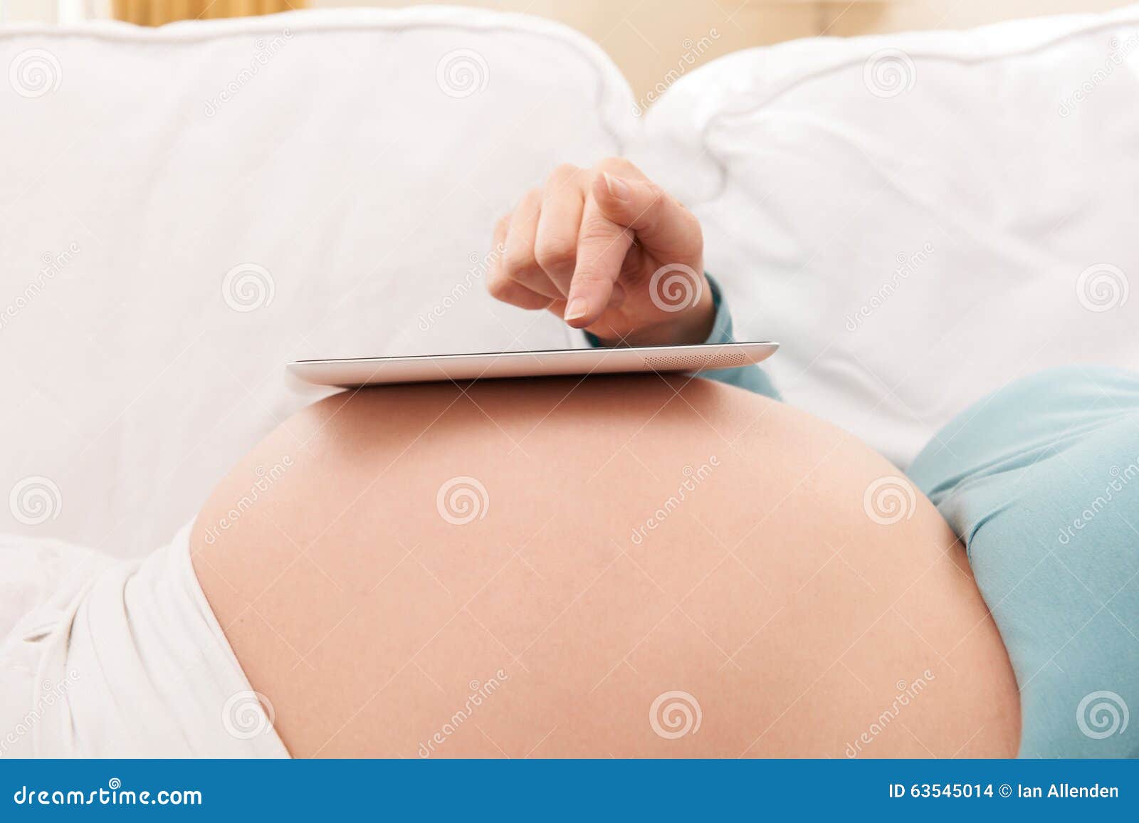 Pregnant Woman with Tablet Computer Resting on Bump Stock Photo - Image ...