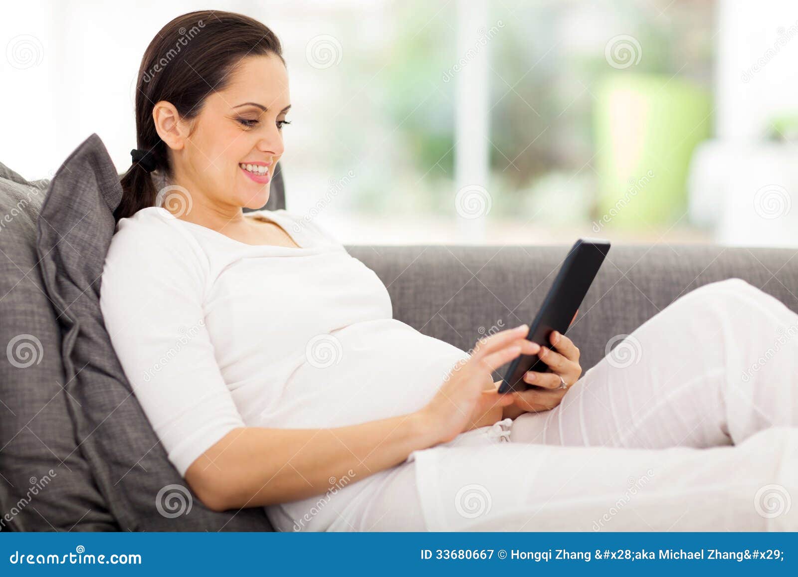 Pregnant woman tablet stock image. Image of computer - 33680667