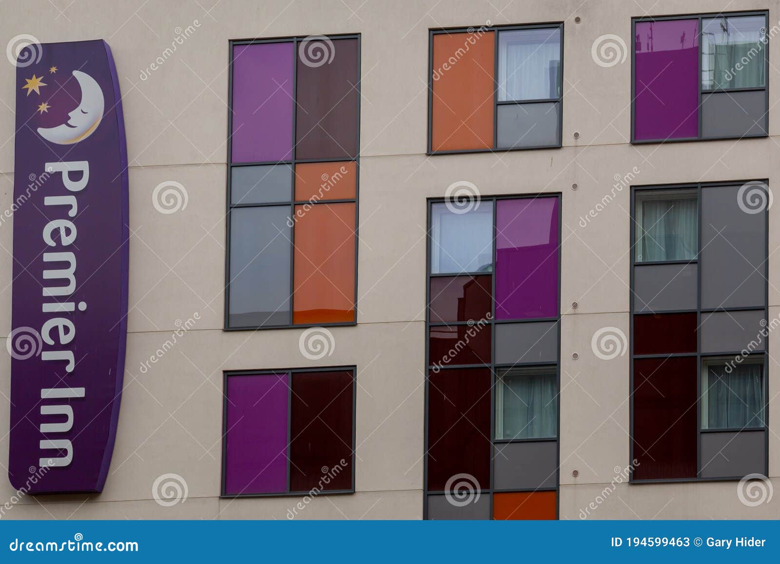 A Premier Inn Hotel Sign and Colourful Windows on the Side of a Premier ...