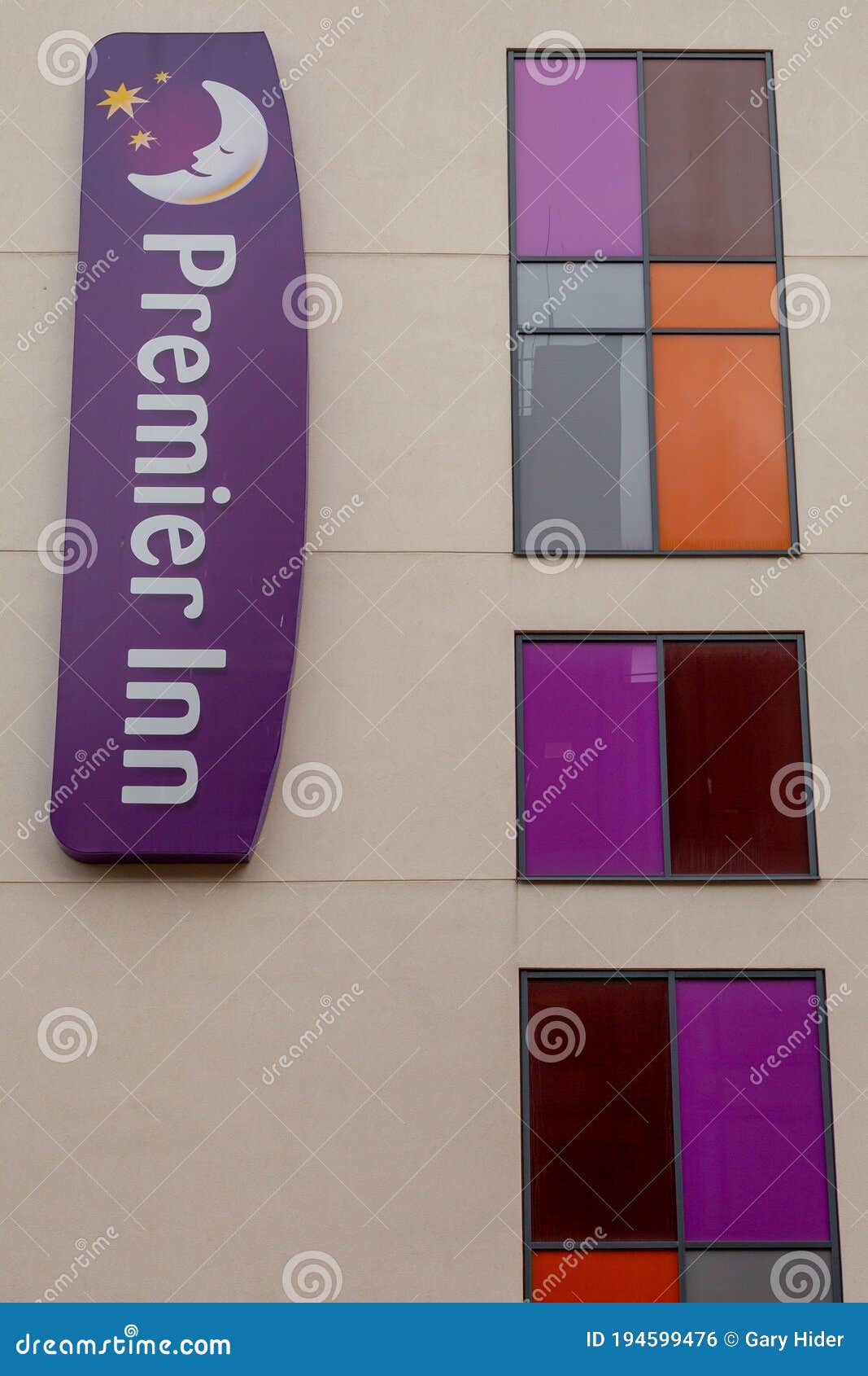 A Premier Inn Hotel Sign and Colourful Windows on the Side of a Premier ...