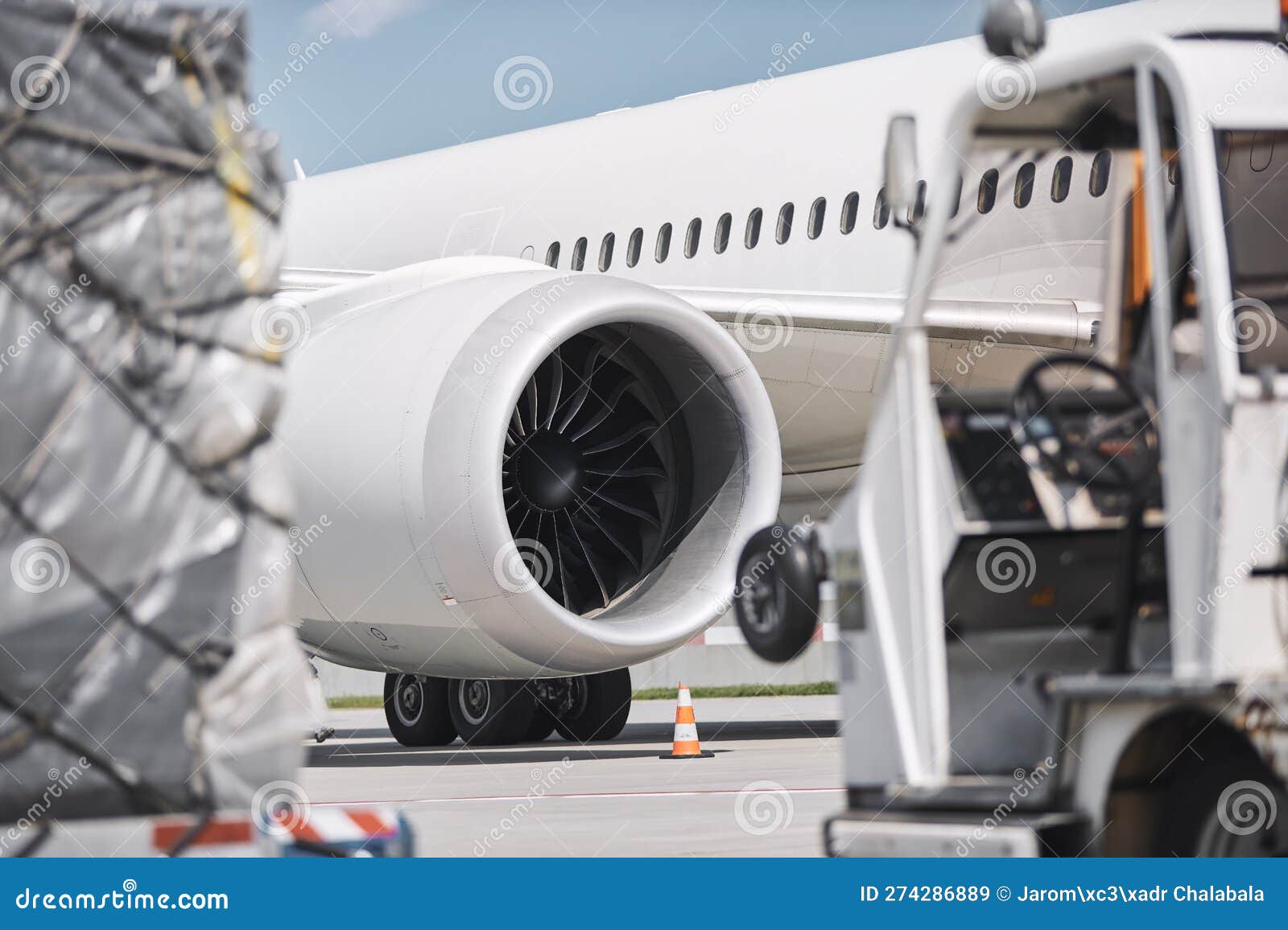 Loading of Cargo Containers Against Jet Engine of Plane Stock Image ...