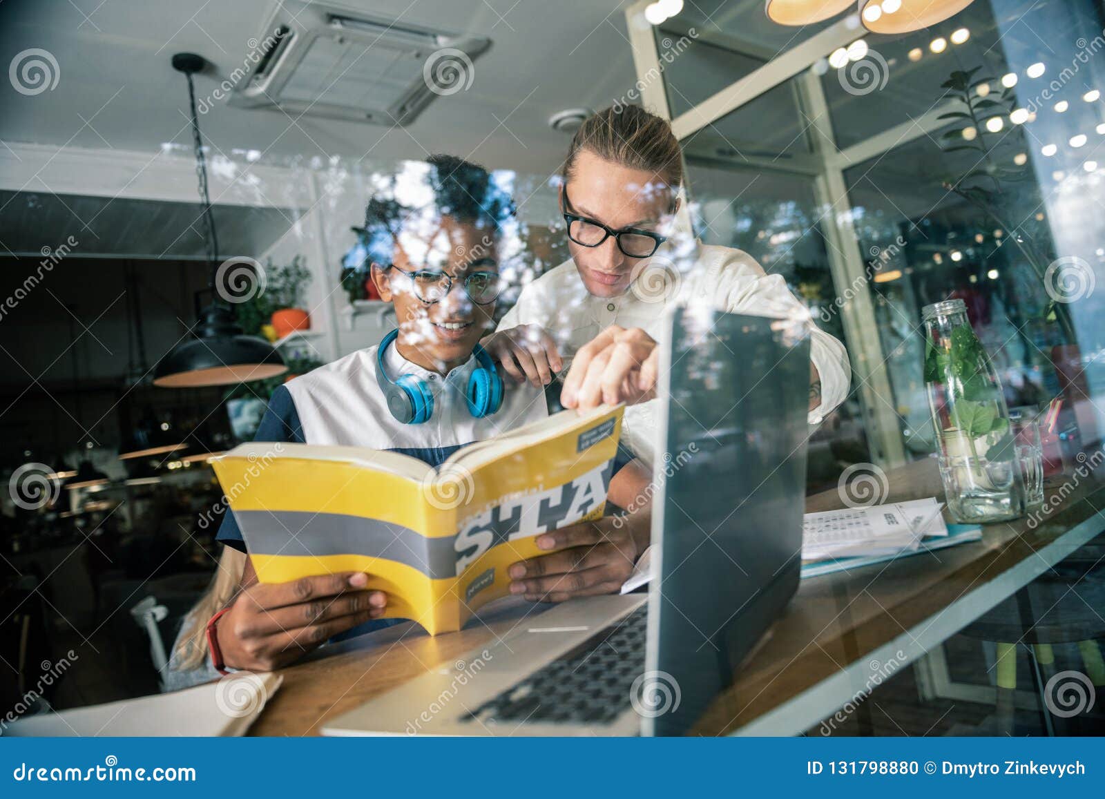 Positive Nice Student Looking into a Book Stock Photo - Image of book ...