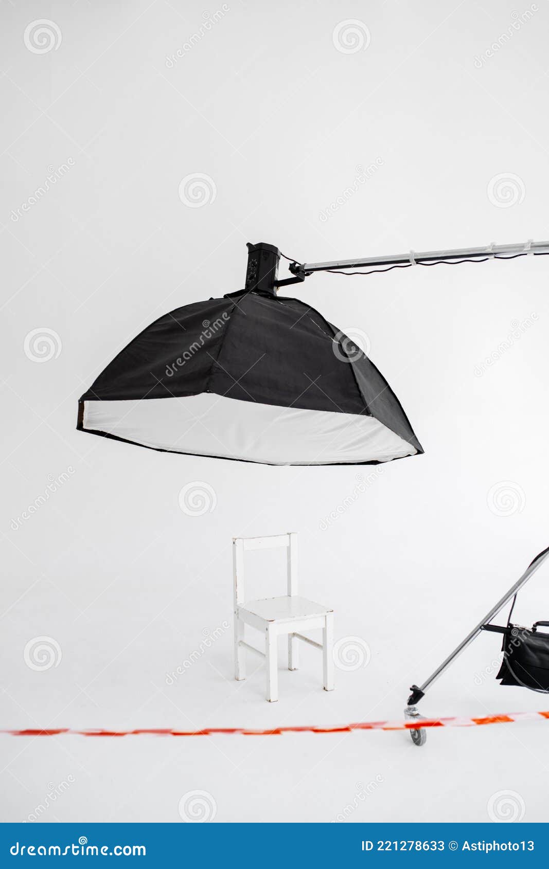 Preparation for Studio Shooting: Empty White Chair and Studio Lighting ...
