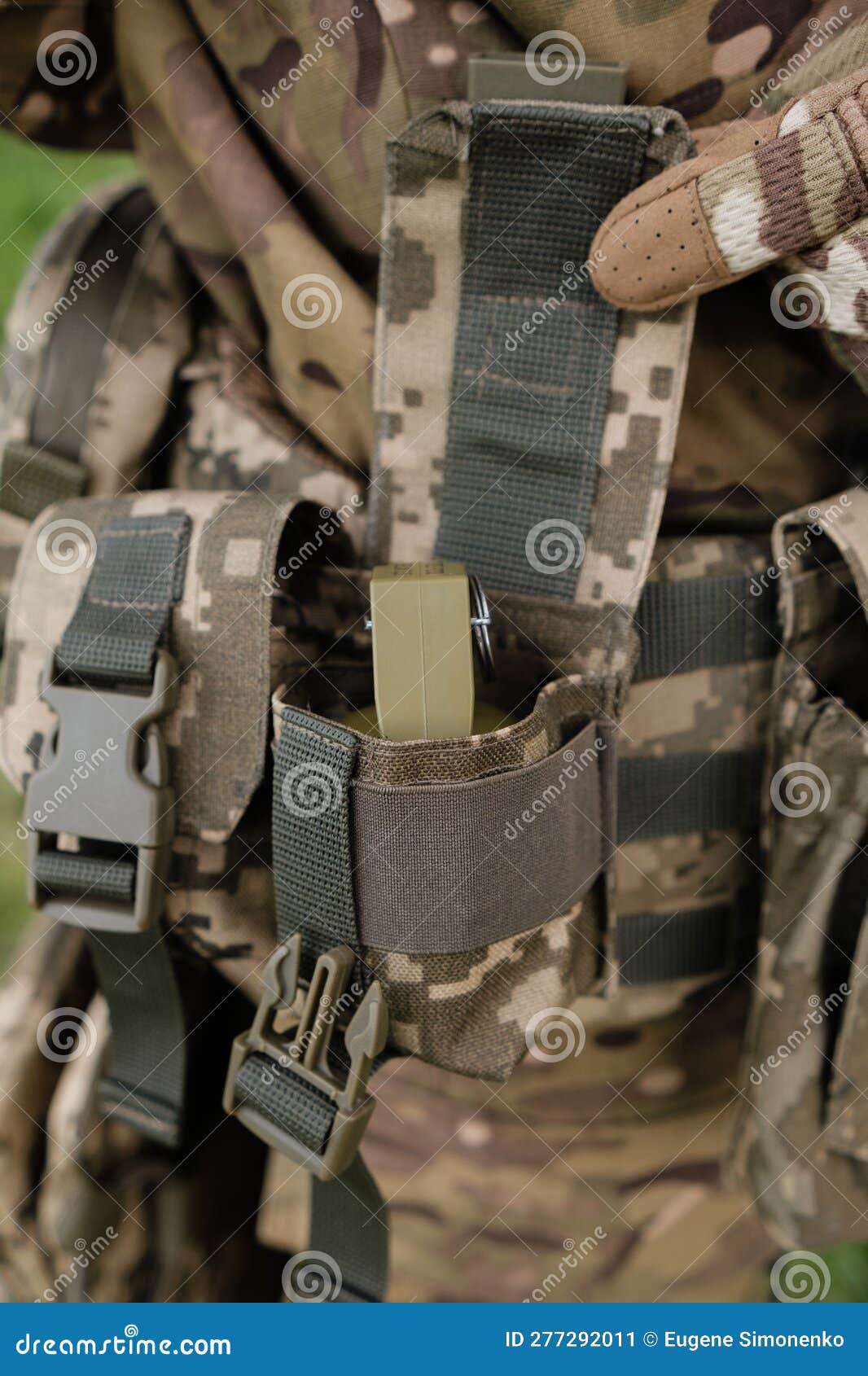 Preparing for Combat: Close-up of Soldier Putting on Gear in the Field ...
