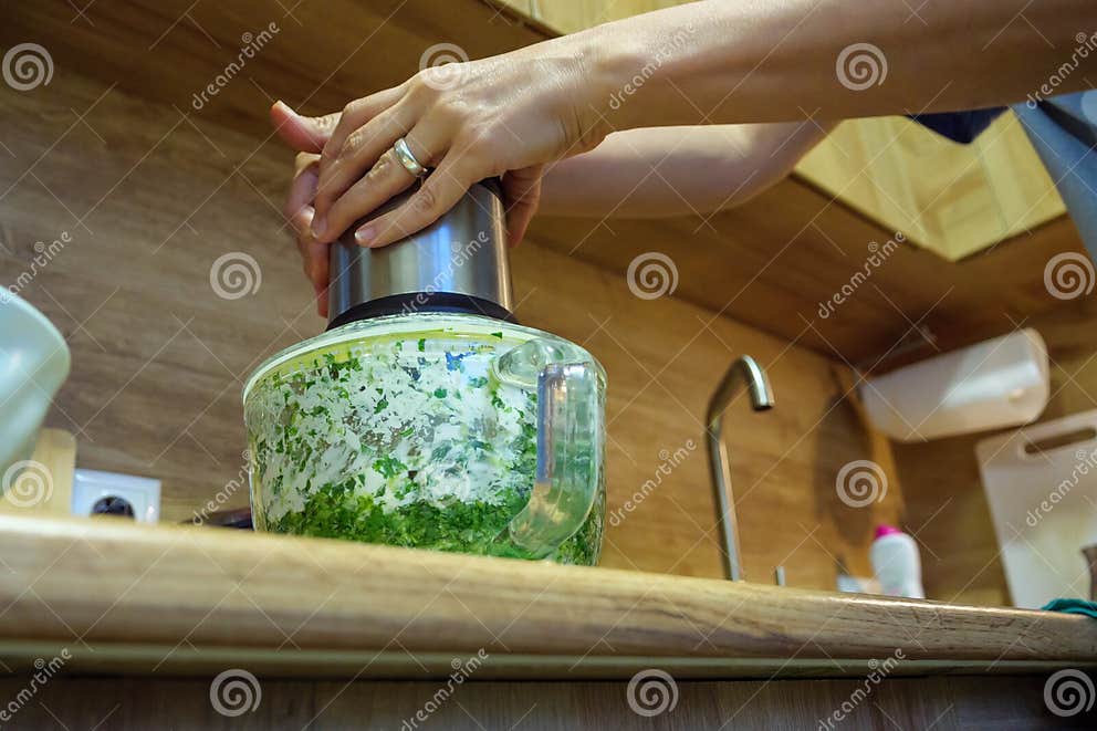 Preparing Fresh Herb Mixture in a Kitchen Using a Food Processor Stock ...