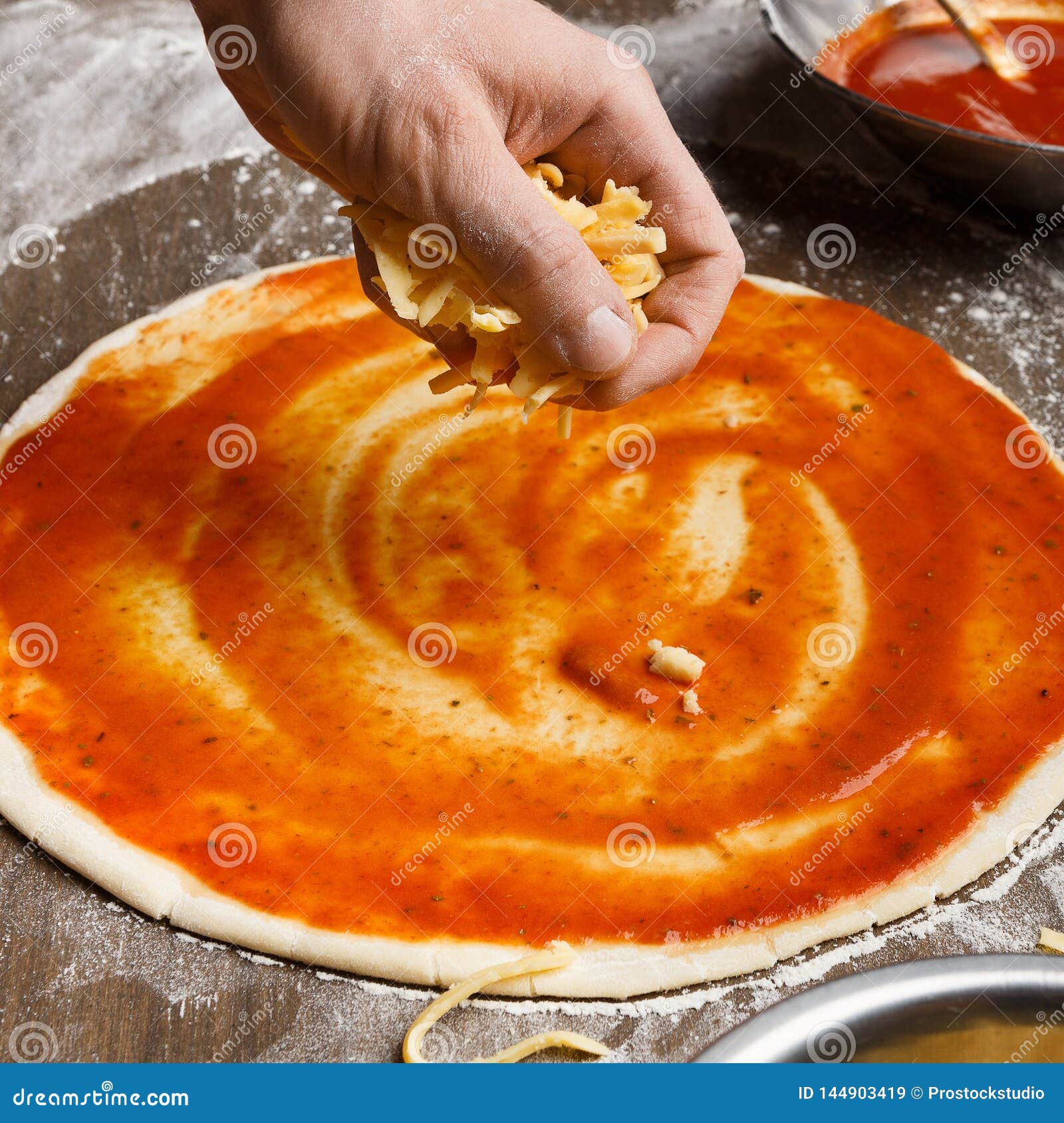 Preparing Italian Dish. Man Adding Cheese on Pizza Base Stock Image ...