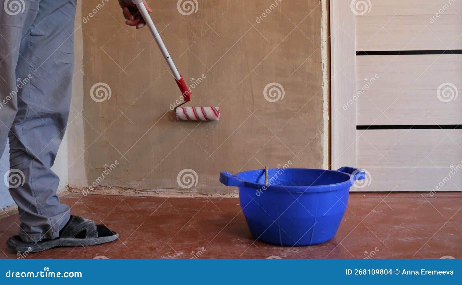 Preparing a Room Wall with a Primer Using Home Equipment Stock Photo ...