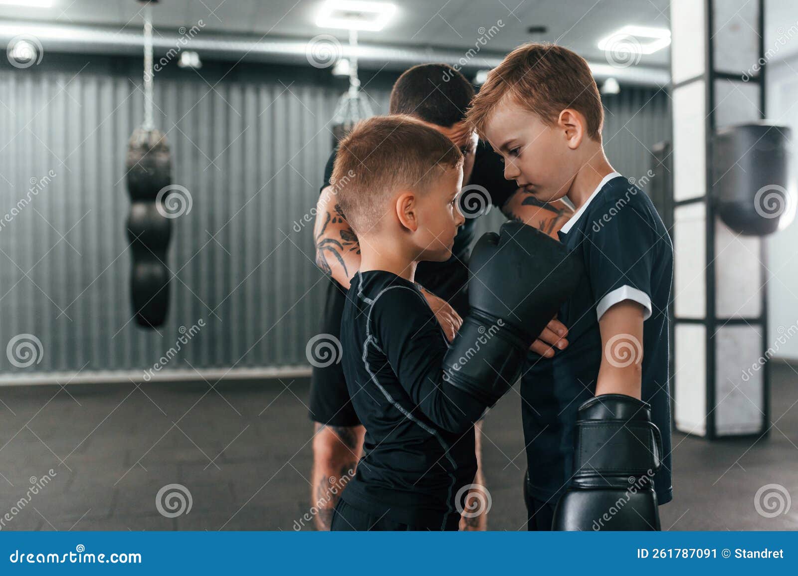 Preparing for the Sparring. Young Tattooed Coach Teaching the Kids ...