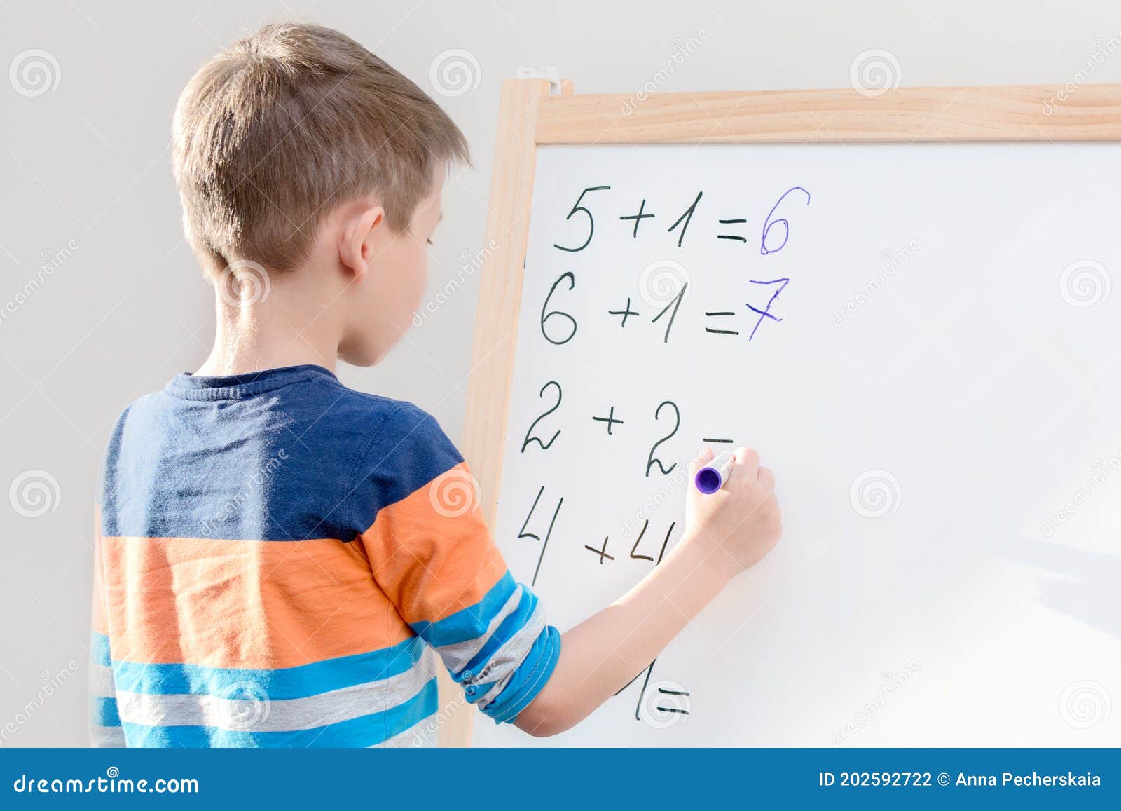 Preschool Boy Stands with His Back To the Camera and Solves a Math ...