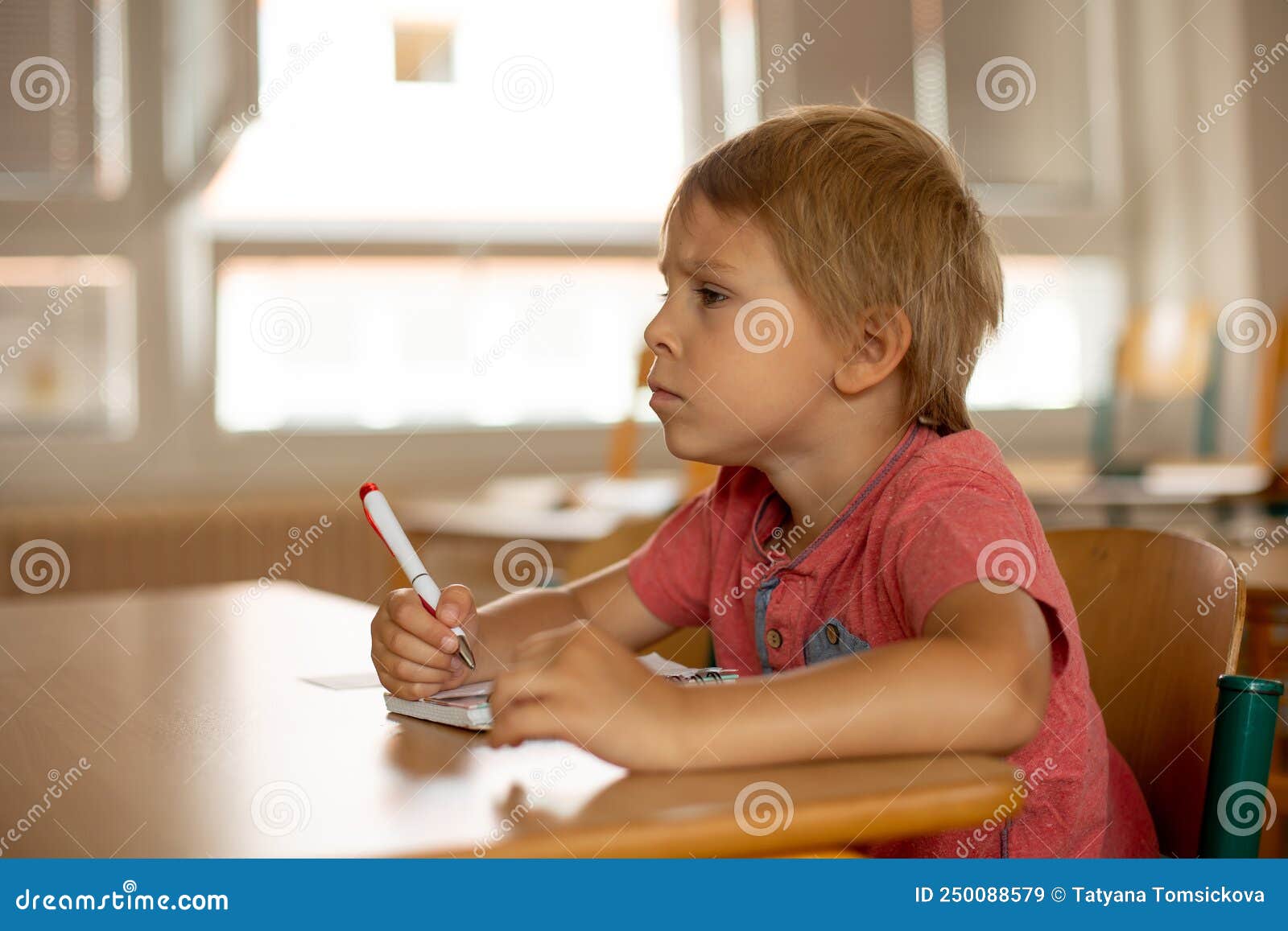 Preschool Child, Sitting on a Desk at School, Having Lesson, Learning ...