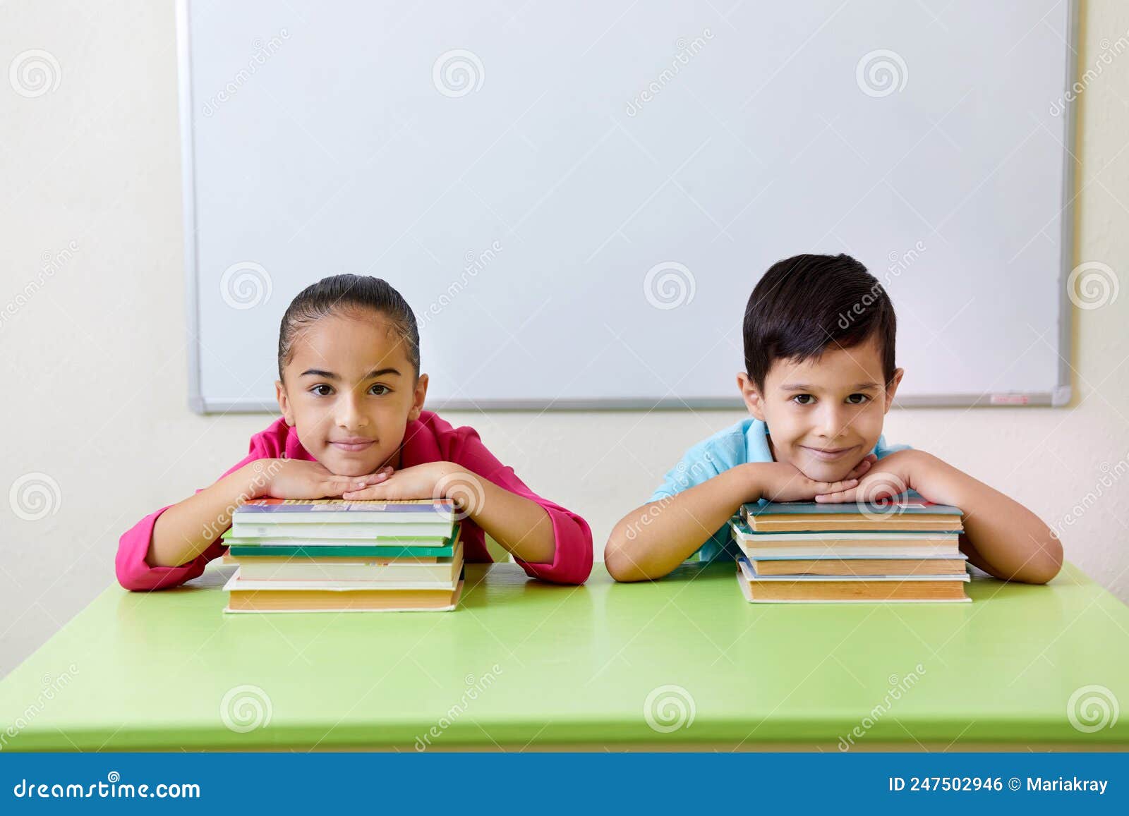 Preschool Children Playing with Books Sitting at a Table Stock Photo ...