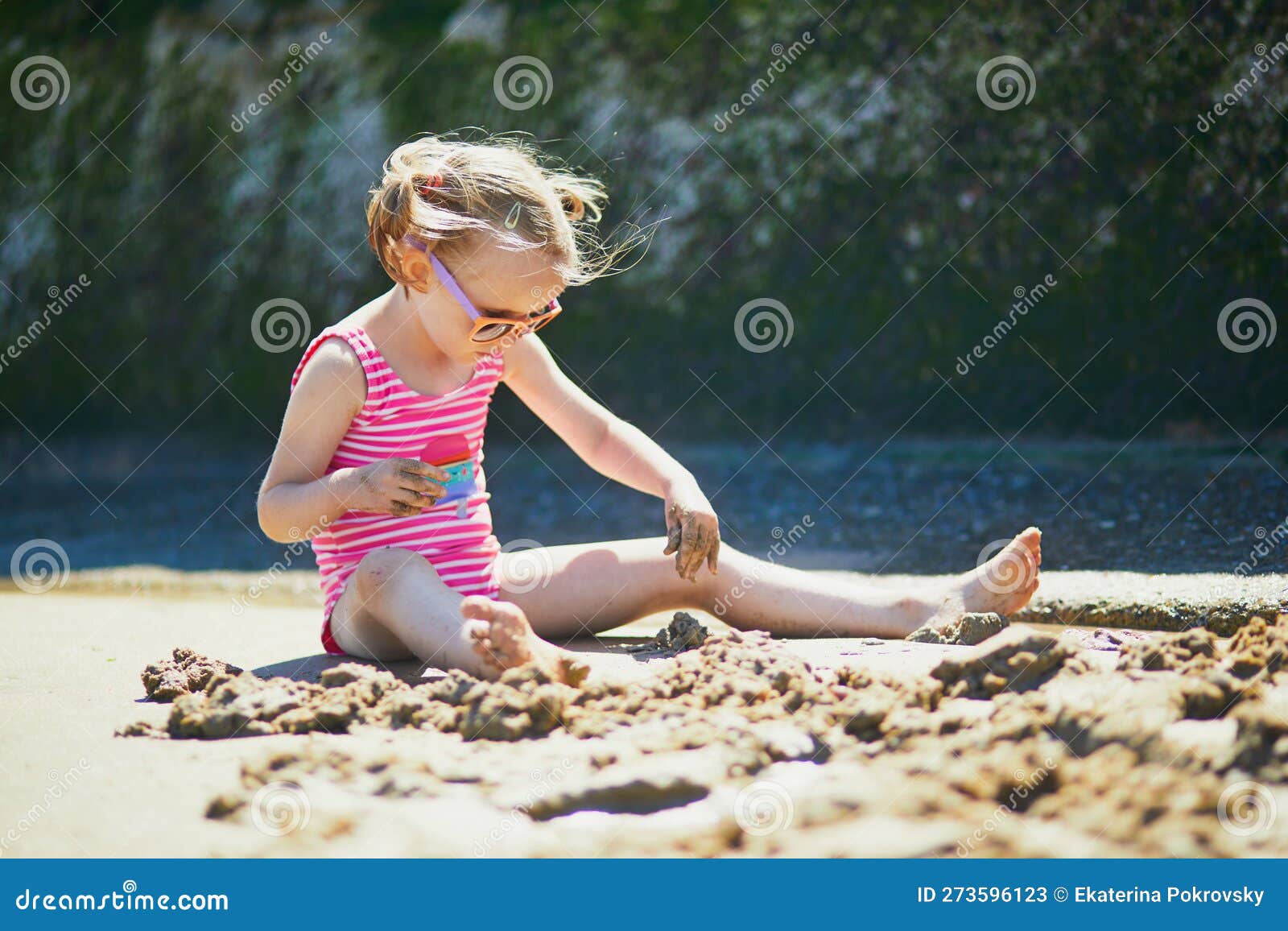 Preschooler Girl Playing On The Sand Beach At Atlantic Coast Of