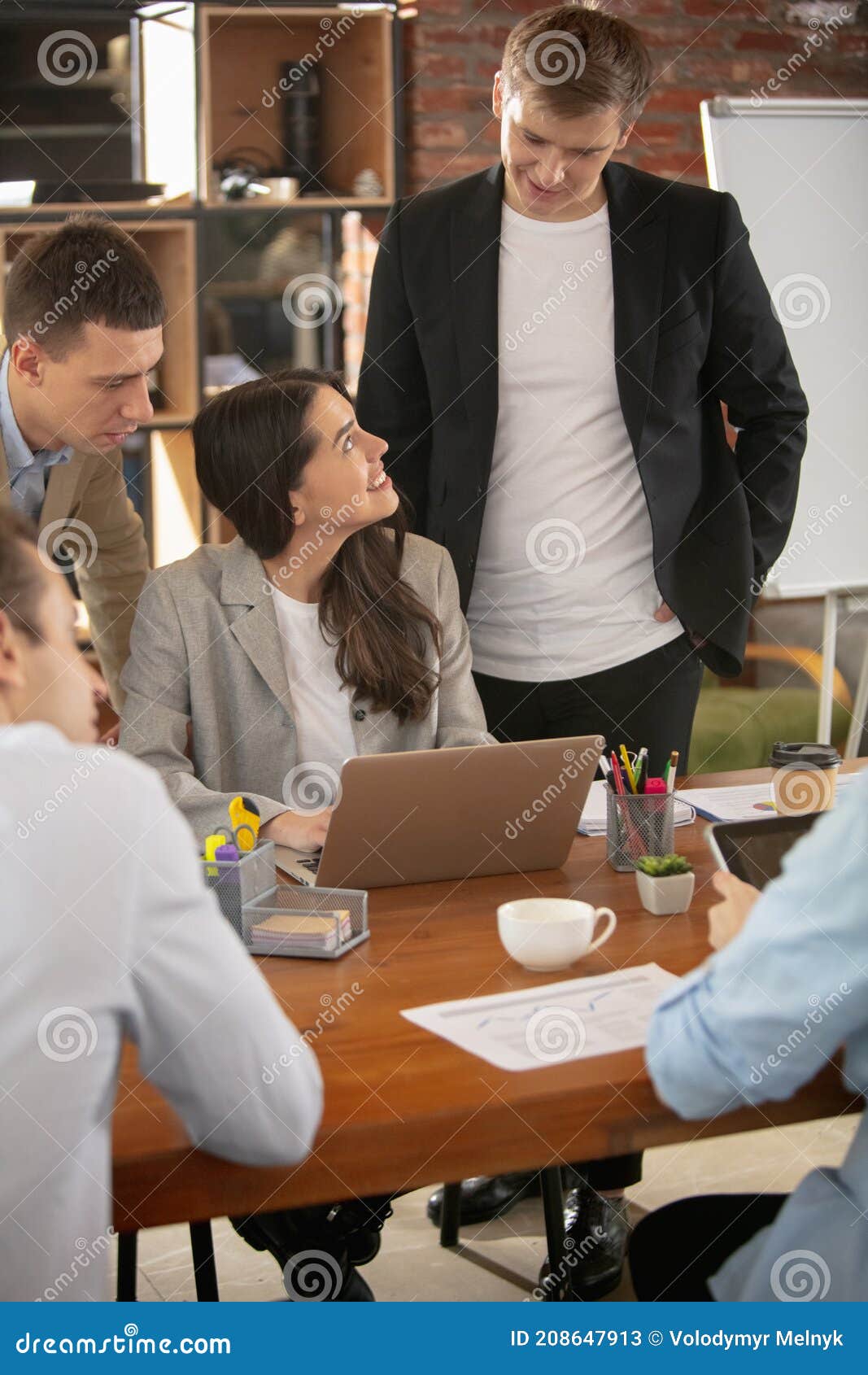 Front View Colleagues Working Together in a Office Using Modern Devices ...