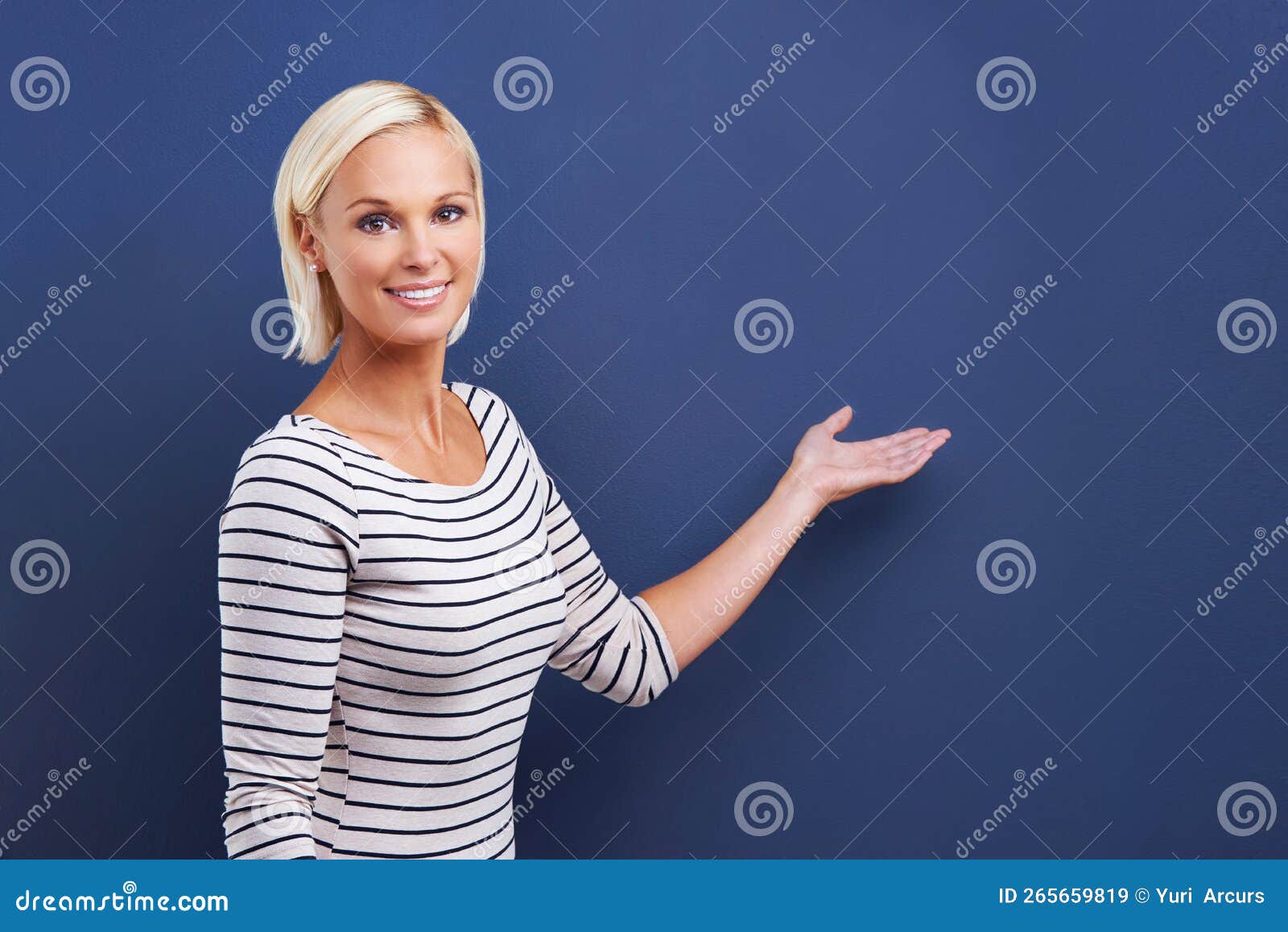 Presenting...Studio Portrait of a Beautiful Young Woman Presenting ...