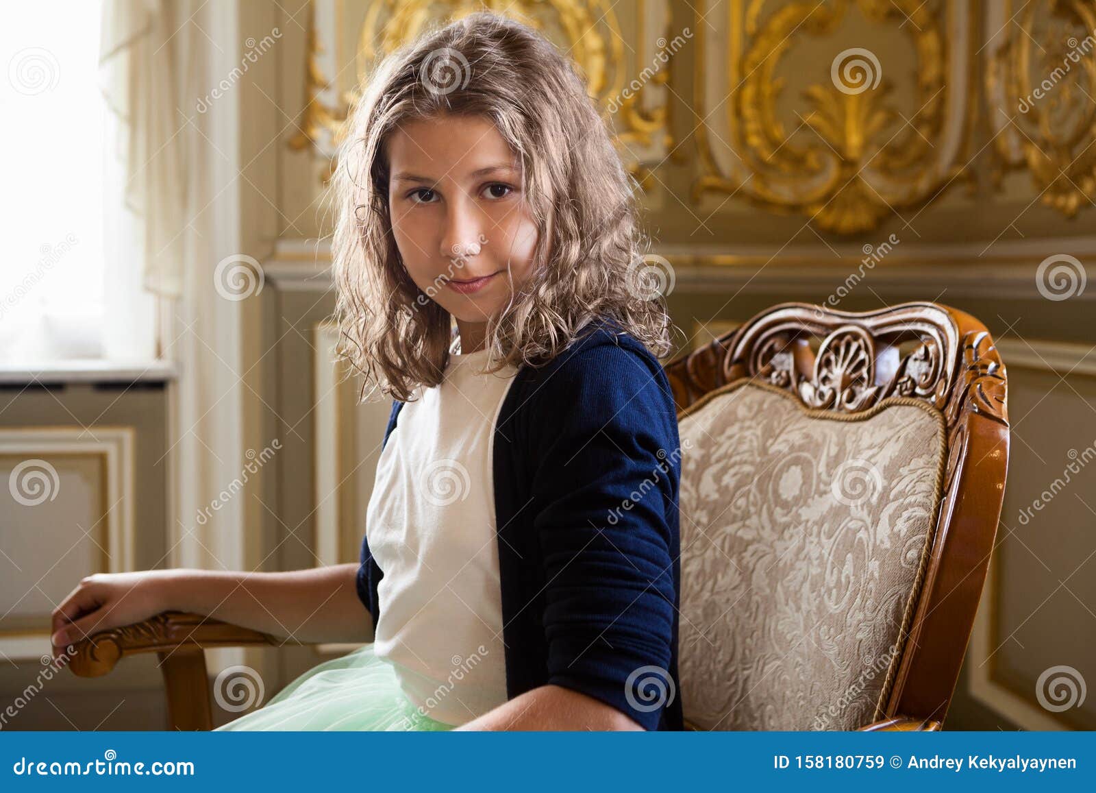 Preteen European Girl Sitting On Old Fashion Armchair Looking At