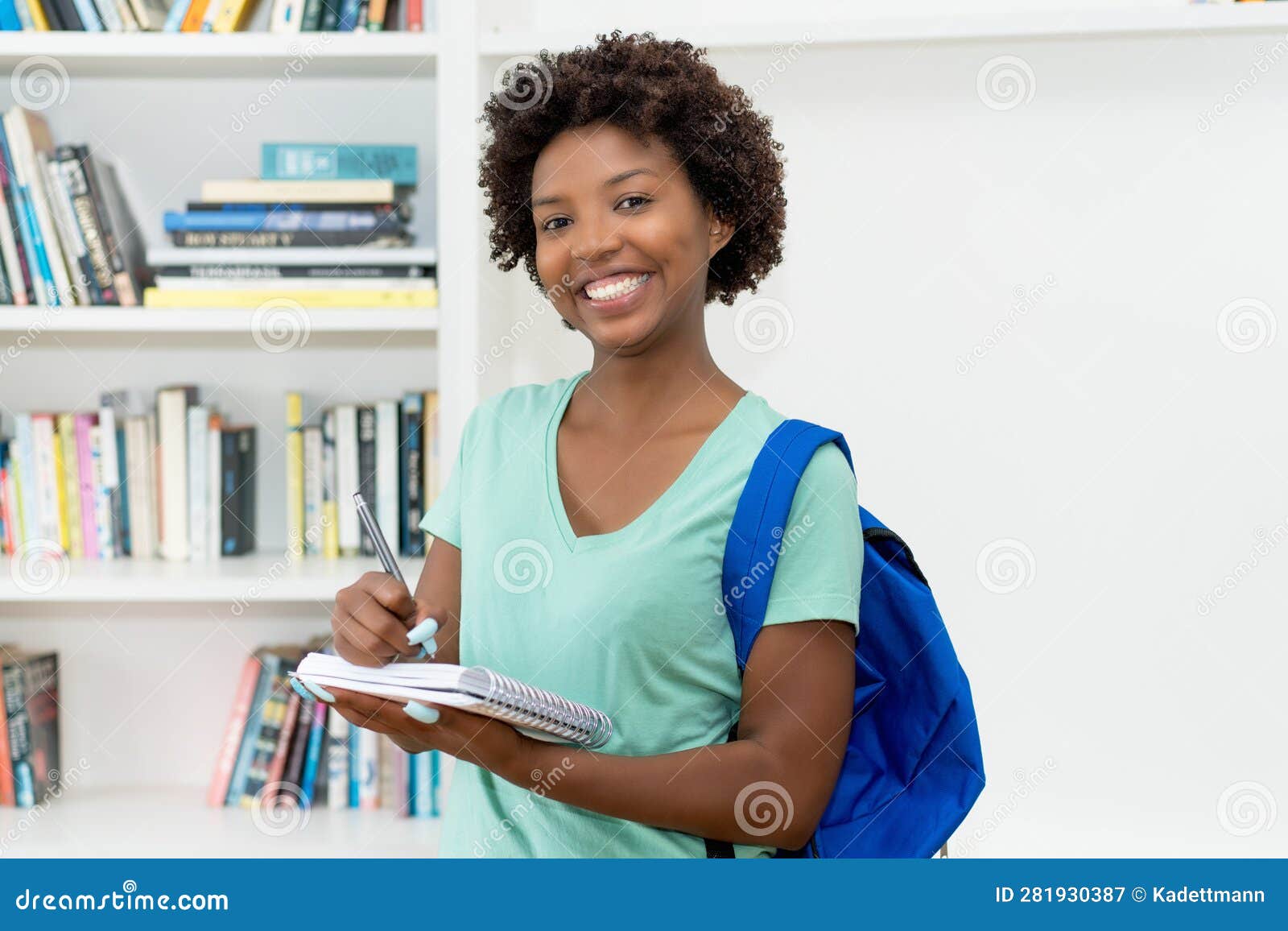Pretty African American Female Student with Backpack Writing Notes ...